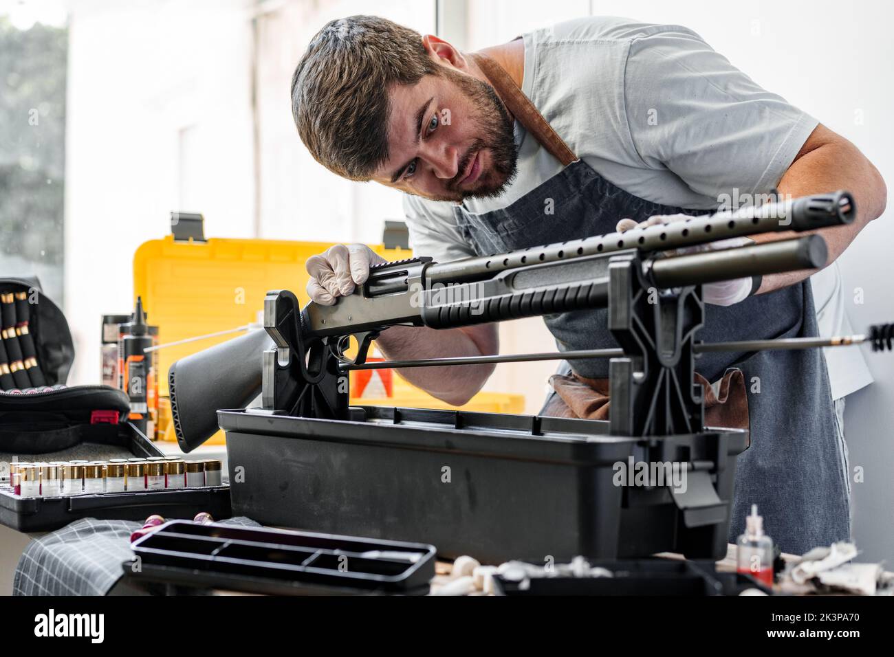 The gunsmith maintaining his rifle in a workshop Stock Photo - Alamy