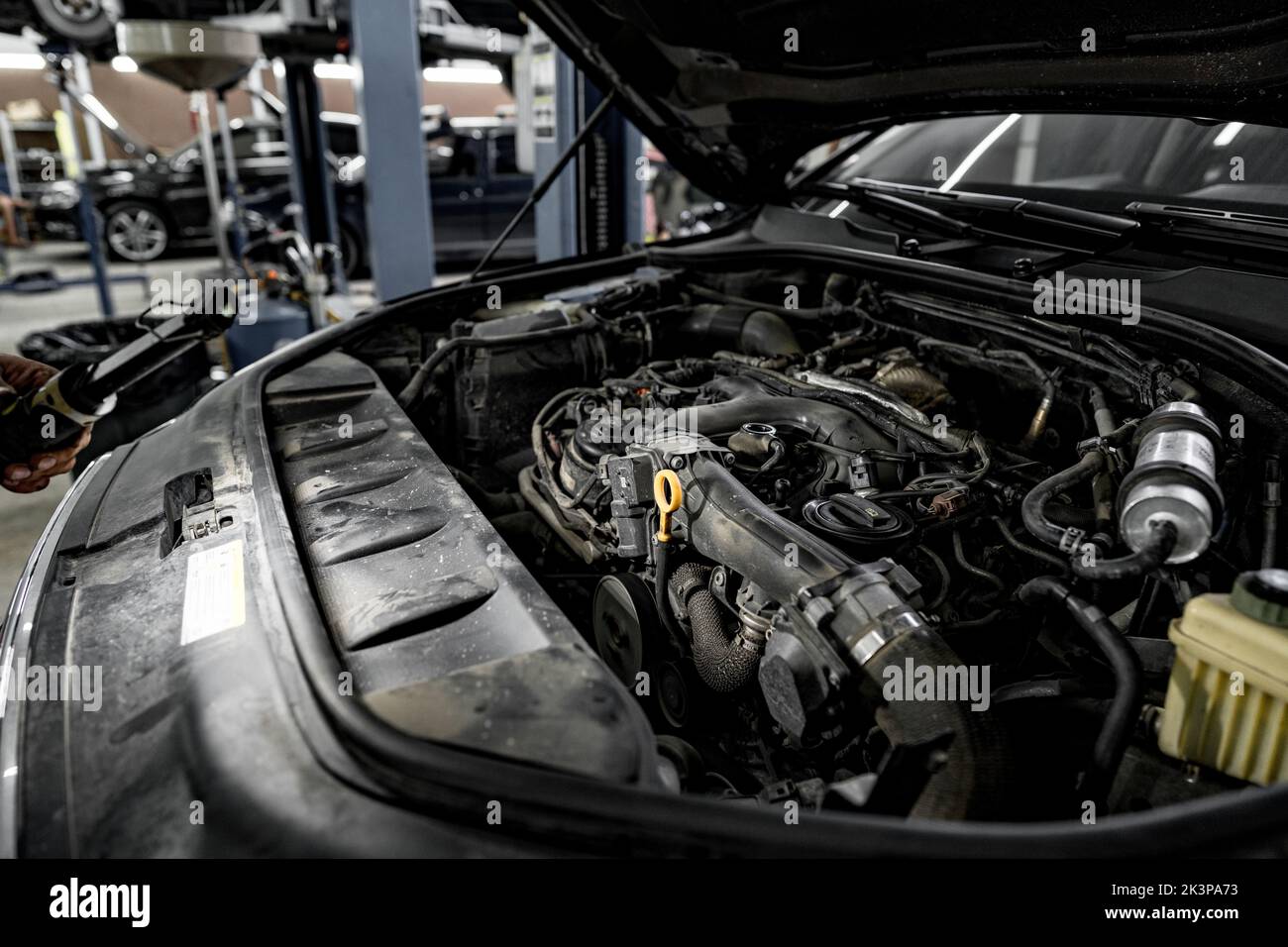 View of engine and other parts under the open hood of a car Stock Photo ...