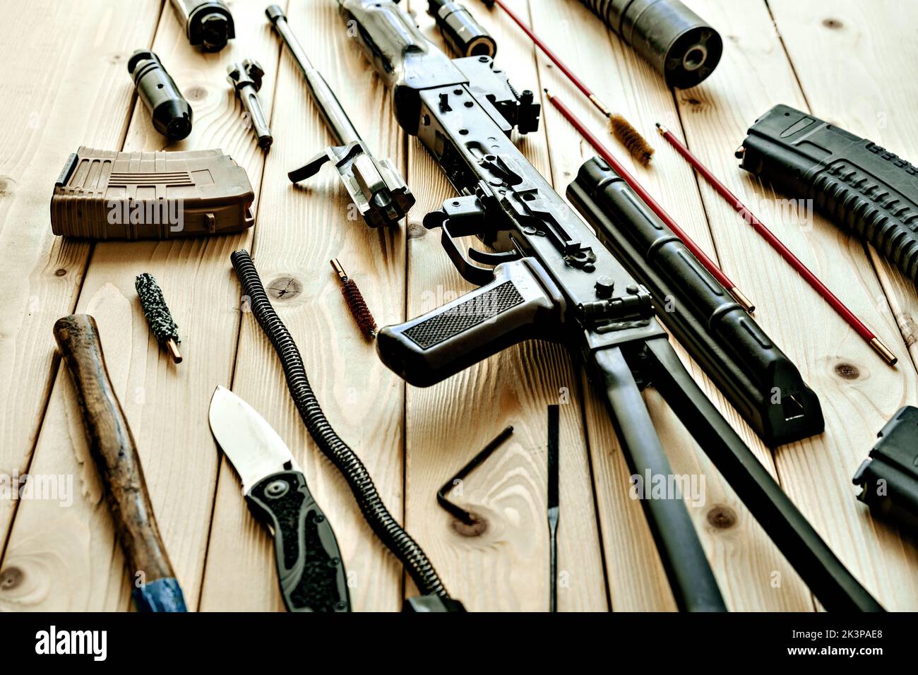 Disassembled rifle with cleaning tools on table of weapons workshop ...
