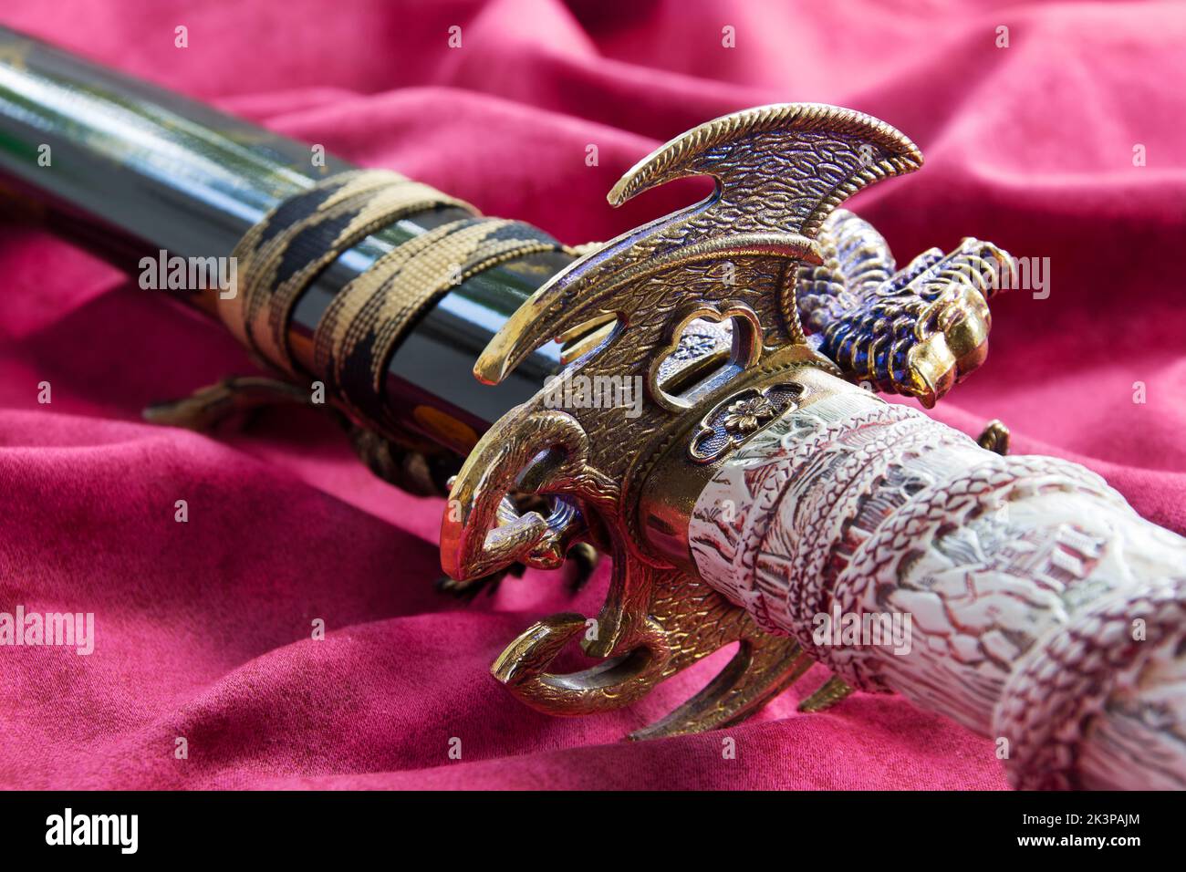Japanese samurai sword over a red fabrics Stock Photo - Alamy