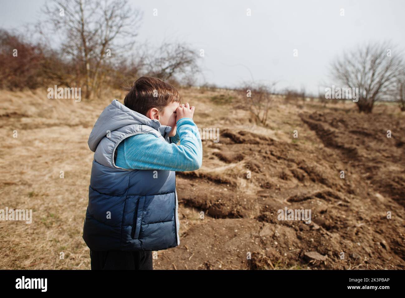 Boy look through hands binoculars Stock Photo - Alamy
