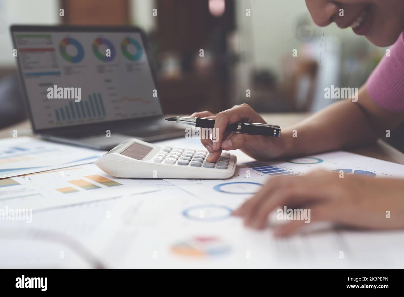 Business woman hand using calculator to calculate the company's ...