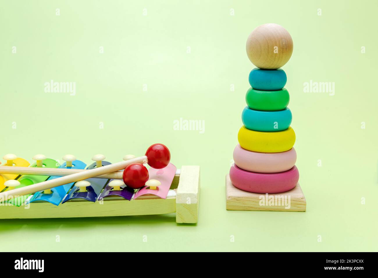 Colorful wooden pyramid and xylophone toy on a colored background Stock ...