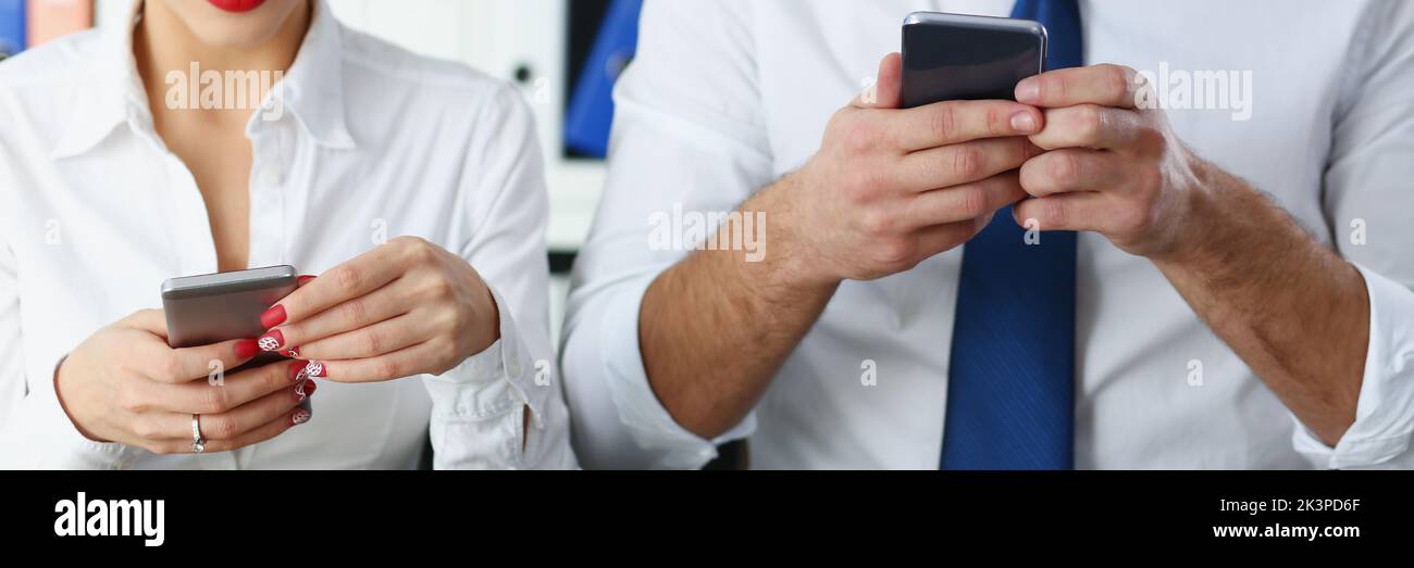 Group of people hold devices and look at phone screen in office Stock ...