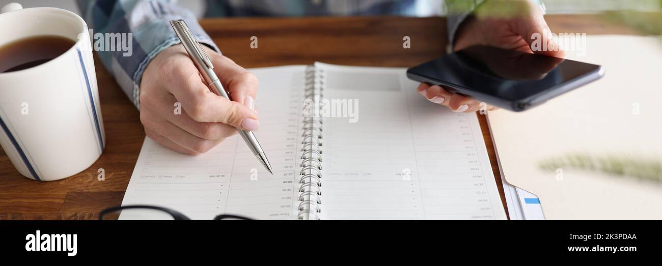 Person start day right with planner and cup of coffee, make appointment ...