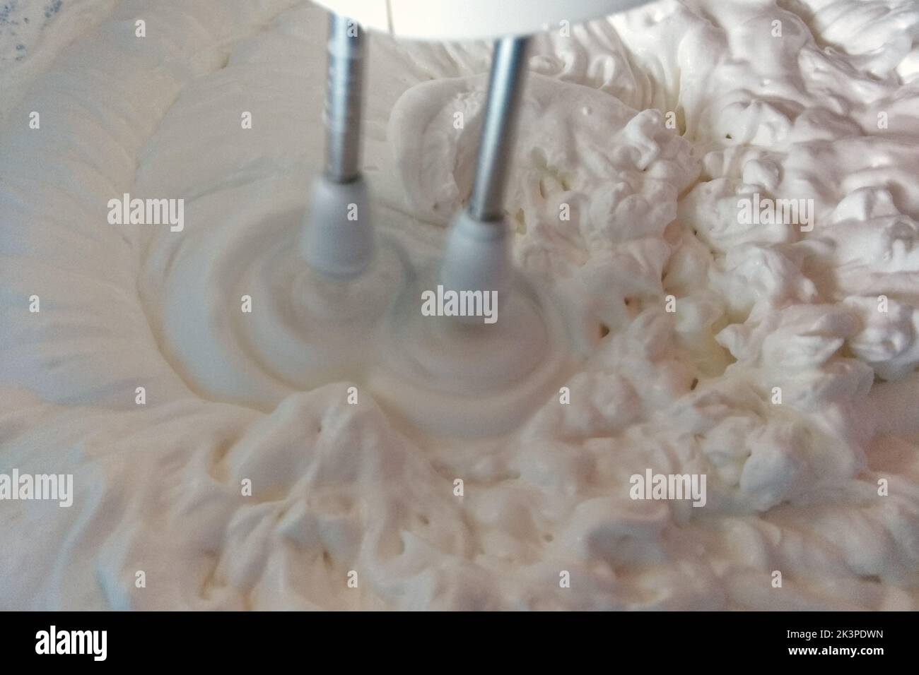 The process of making a whipped cream with a mixer Stock Photo - Alamy