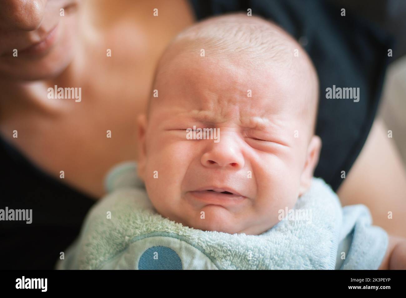 Sweet and cute small little newborn baby is hungry and upset and cry ...