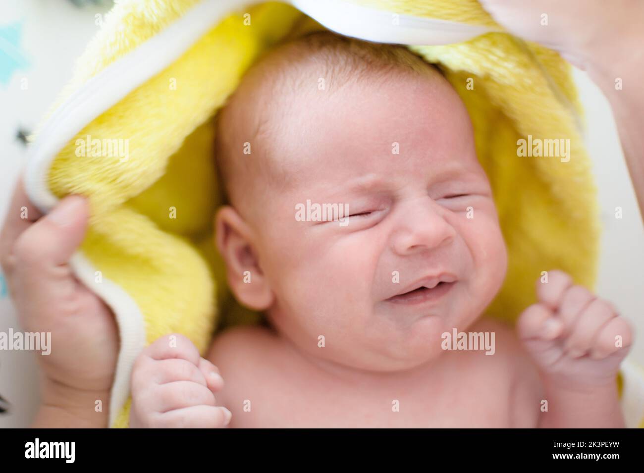 Sweet and cute small little newborn baby is hungry and upset and cry strongly inviting her ...