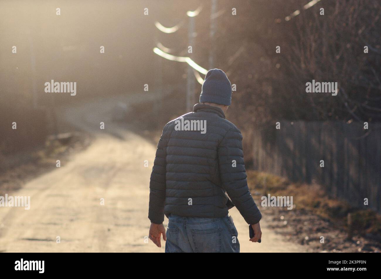 A man standing backward on a road Stock Photo - Alamy