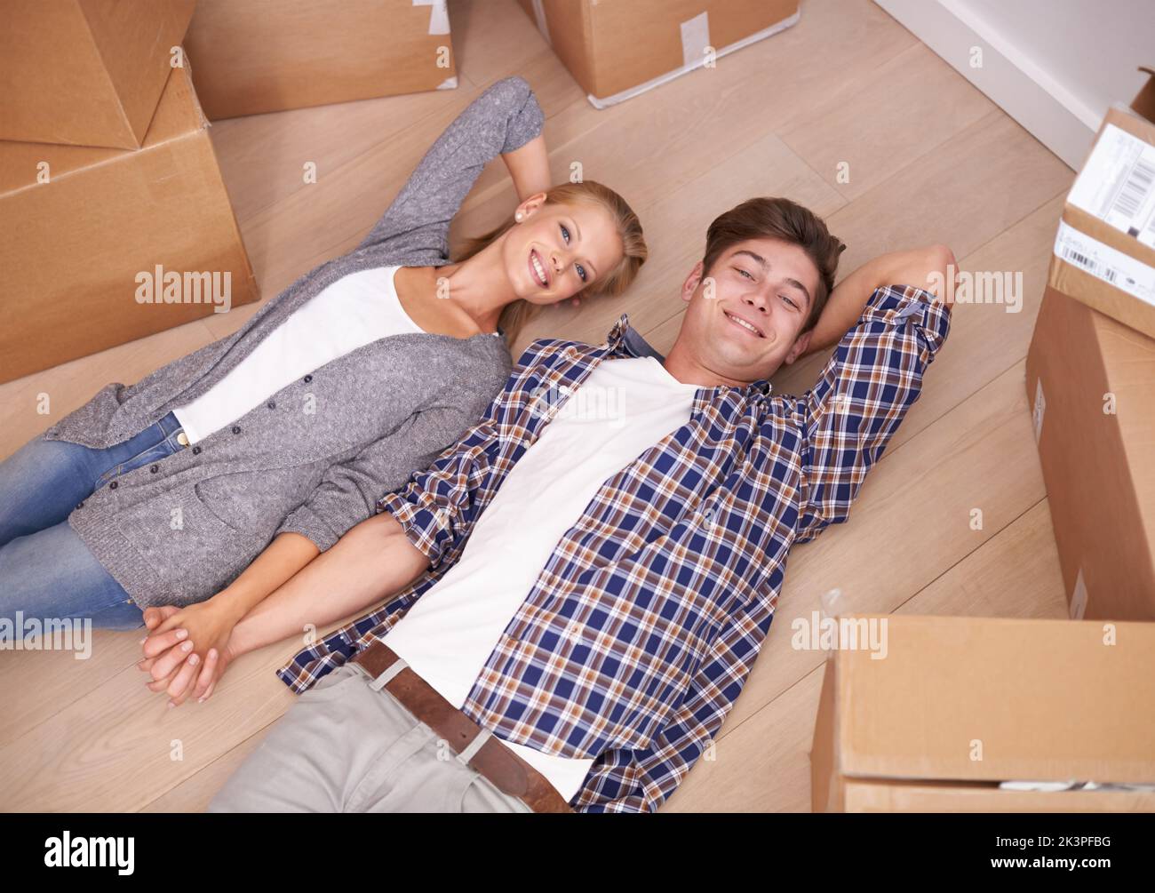 Exhausted after moving day. a couple lying on the floor happily after a ...