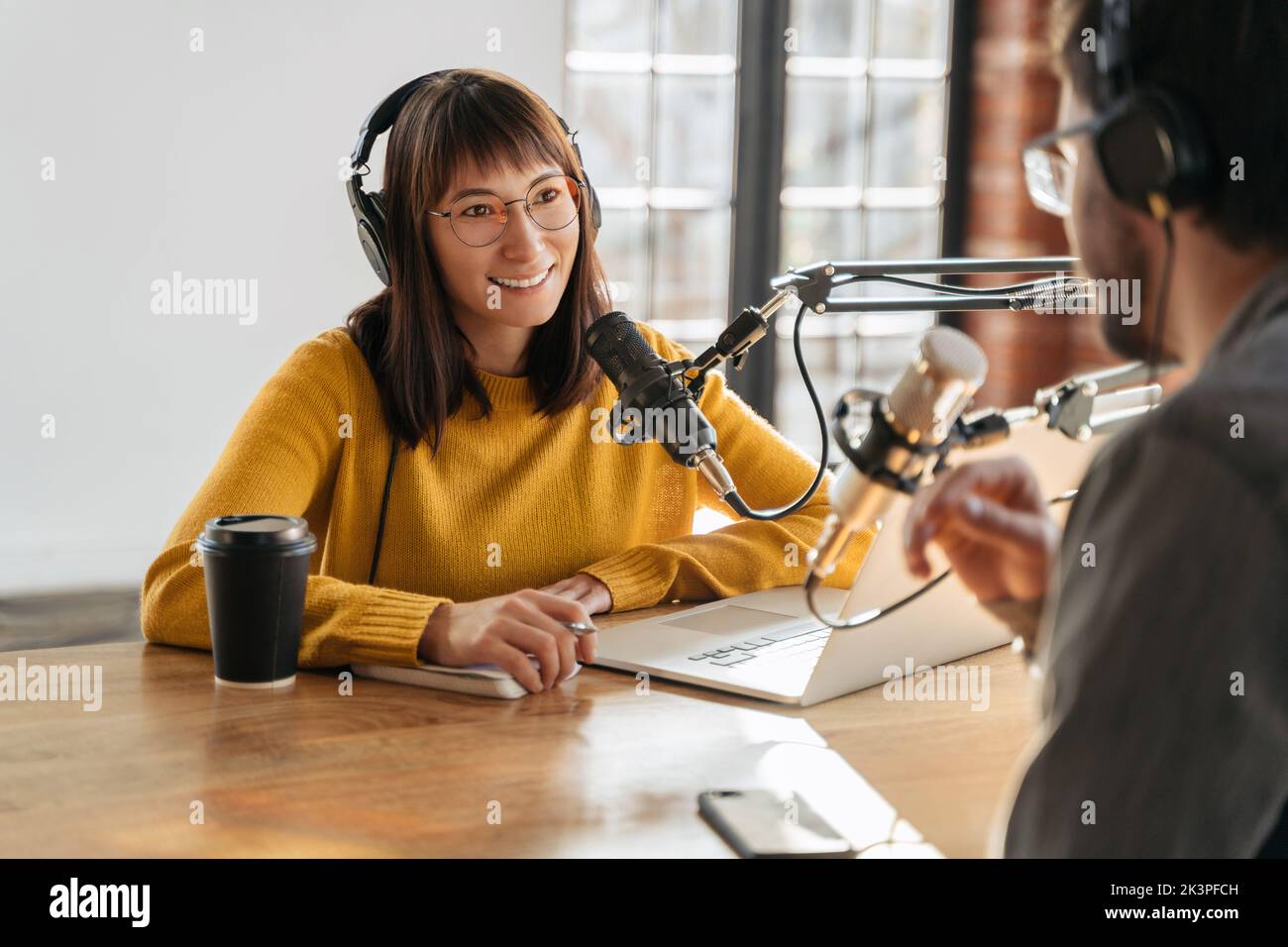 Podcasting. Man and woman podcasters interview each other for radio ...