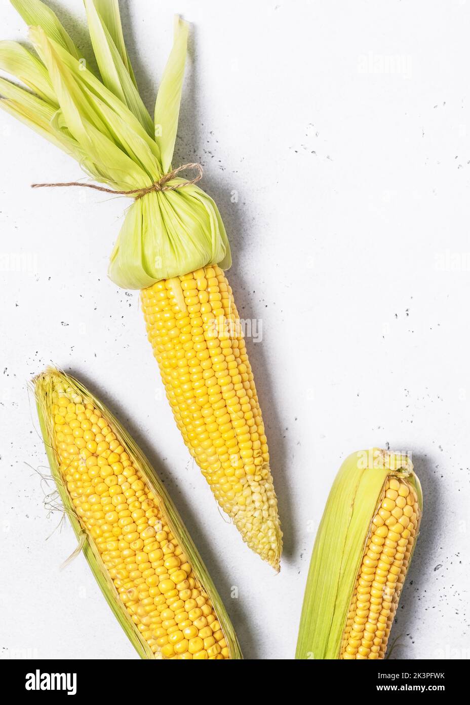 Top view of raw organic super sweet corns with corn silk and skin on ...