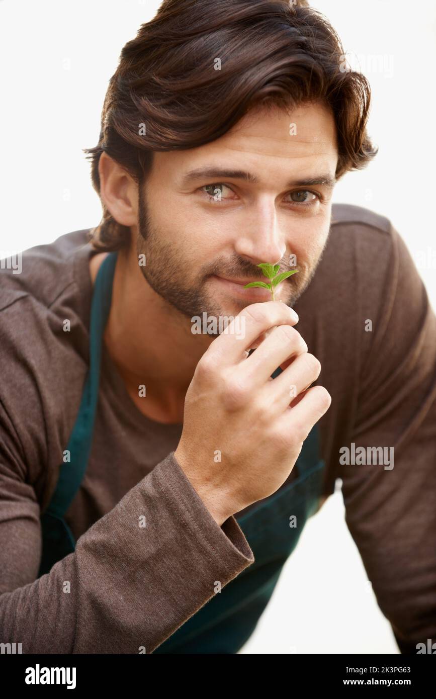 Breathe in natures goodness. A handsome bearded man smelling fresh ...