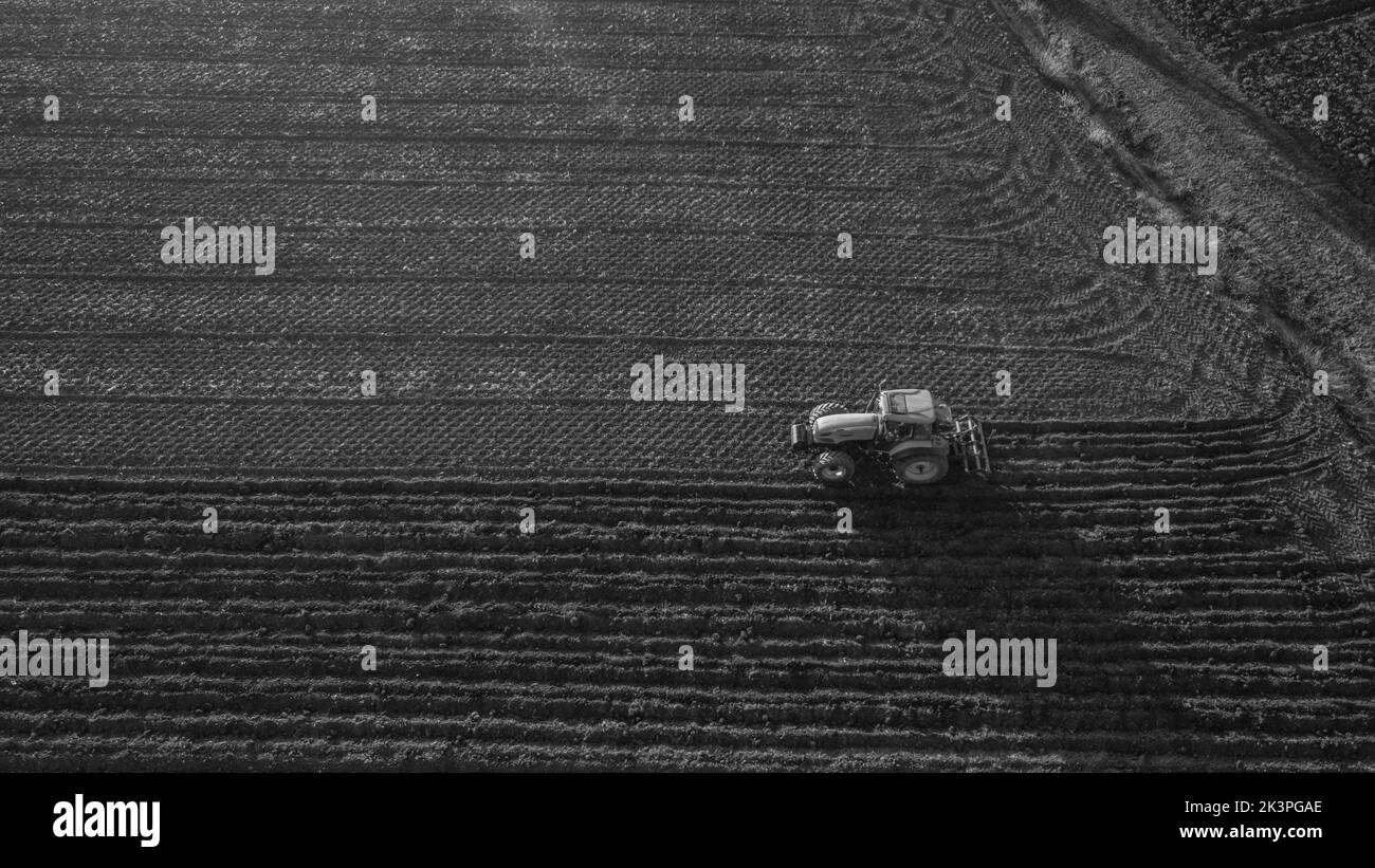 farmer with tractor leveling land in the countryside Stock Photo - Alamy