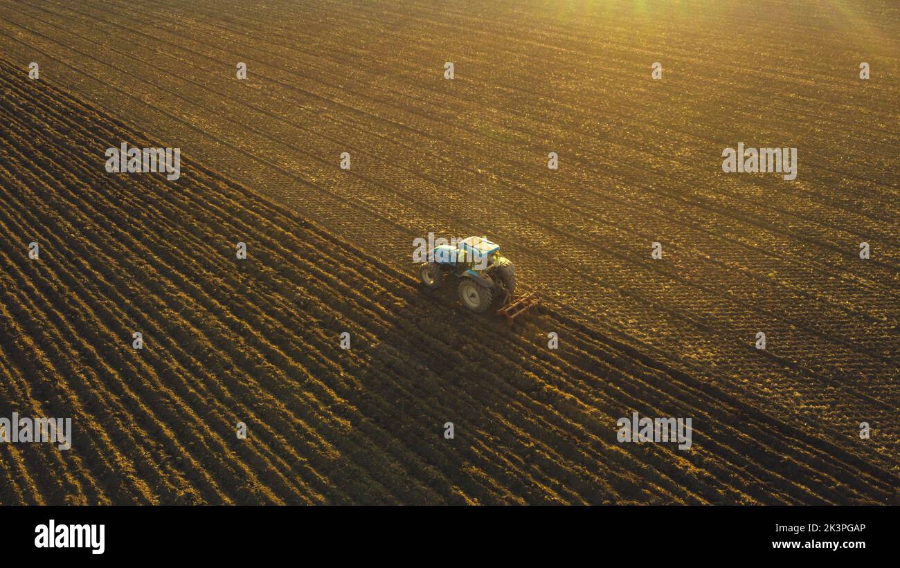 farmer with tractor leveling land in the countryside Stock Photo - Alamy