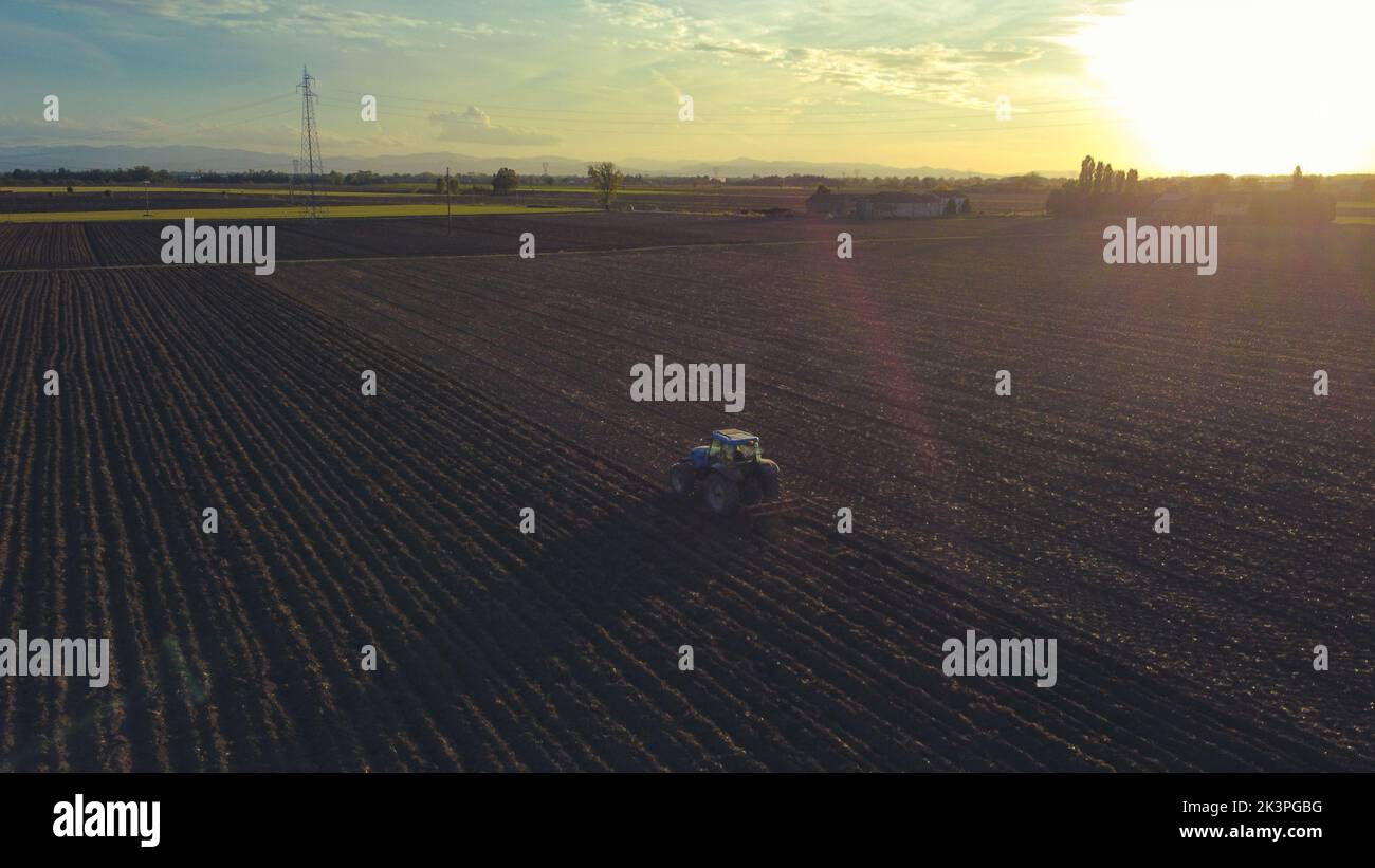 farmer with tractor leveling land in the countryside Stock Photo - Alamy