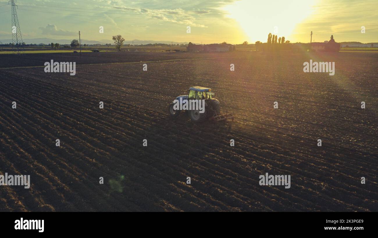 farmer with tractor leveling land in the countryside Stock Photo - Alamy