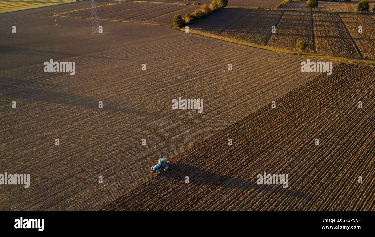 farmer with tractor leveling land in the countryside Stock Photo - Alamy