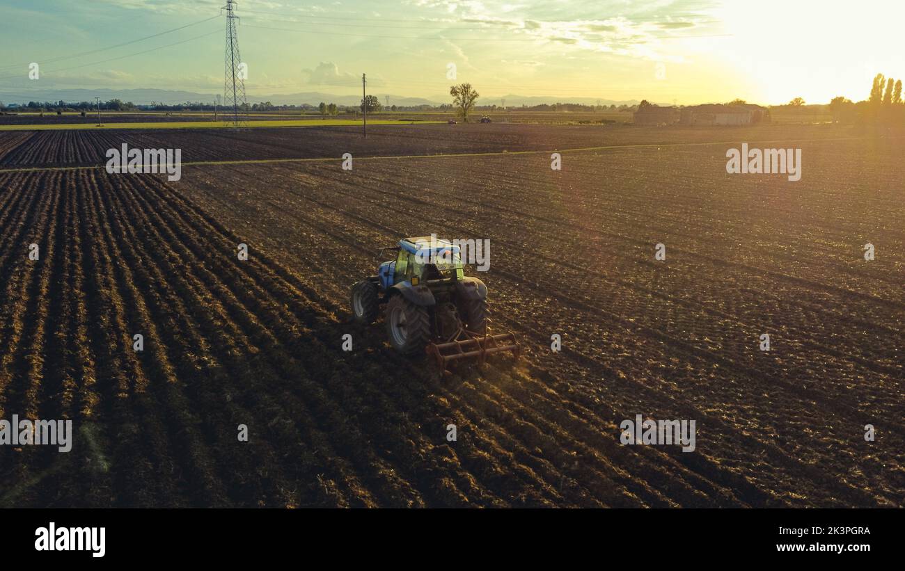 farmer with tractor leveling land in the countryside Stock Photo - Alamy