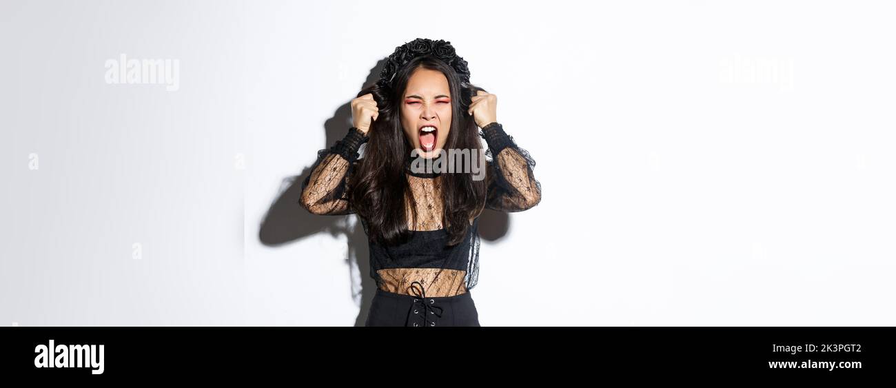 Image of angry distressed asian woman screaming and ripping hair of ...