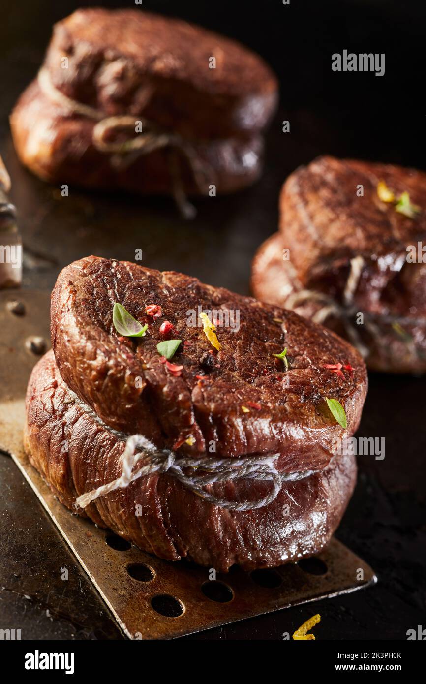 From above yummy beef medallion with spices served for lunch on spatula ...