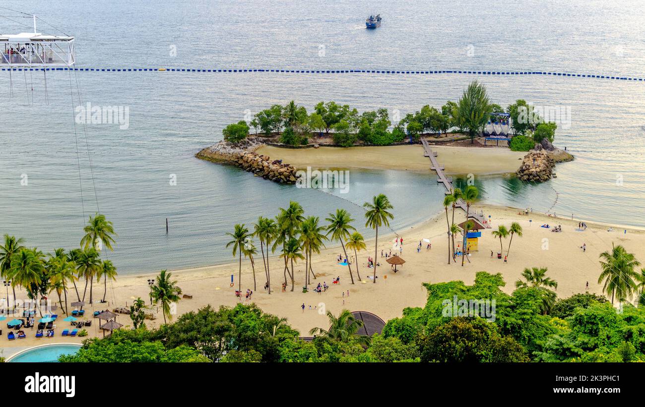 Aerial view of Siloso beach at Sentosa, Singapore. People having fun on ...