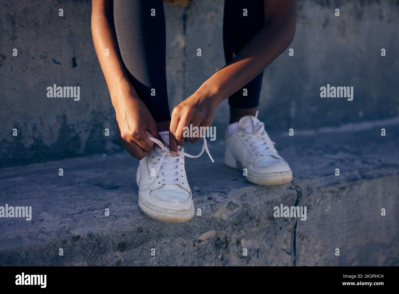 Safety first. Keep your laces tied. High angle shot of an unrecognizable woman tying her laces ...