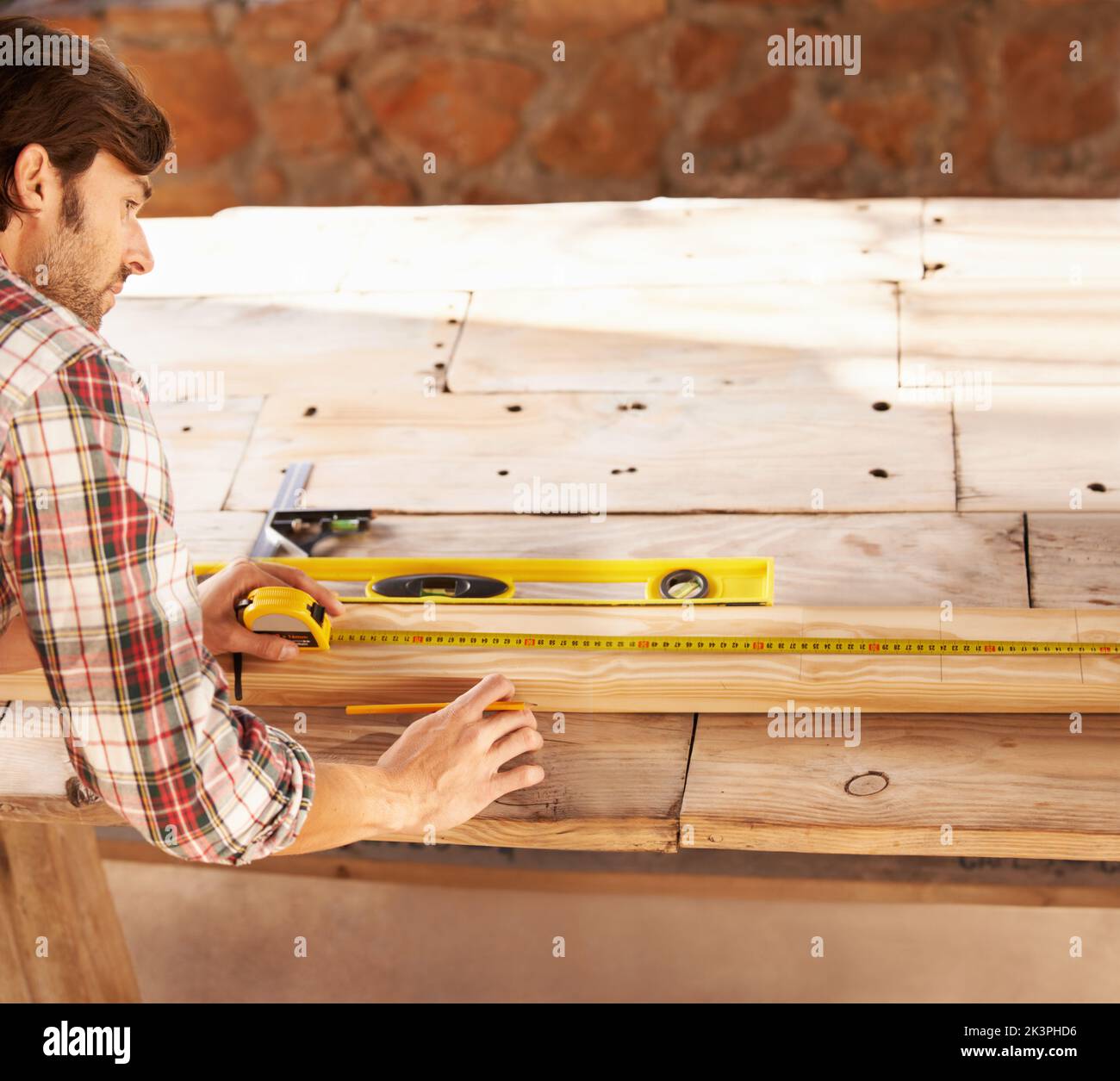 Getting his measurements just perfect. A handyman getting his ...