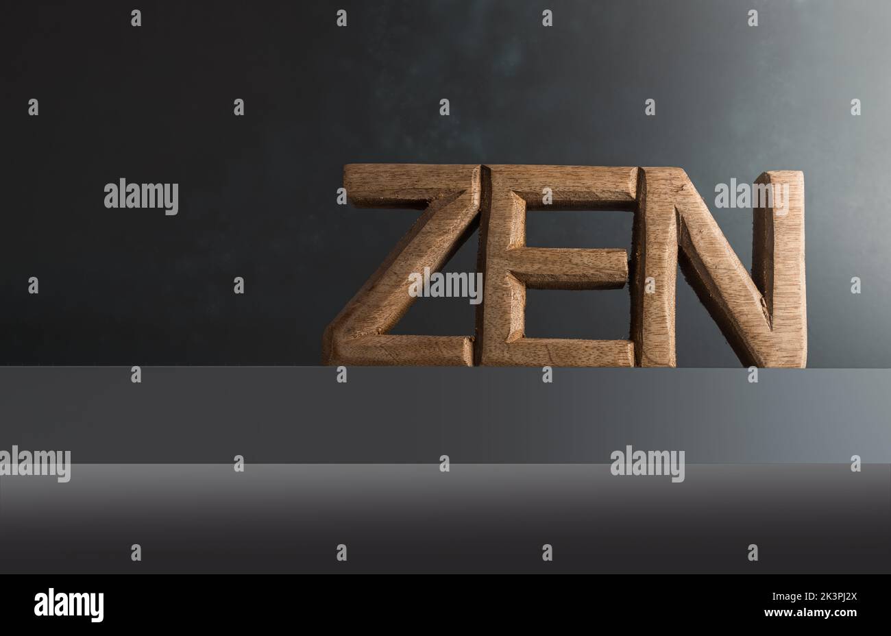 the word Zen carved in wooden letters on a grey background ,concept of ...