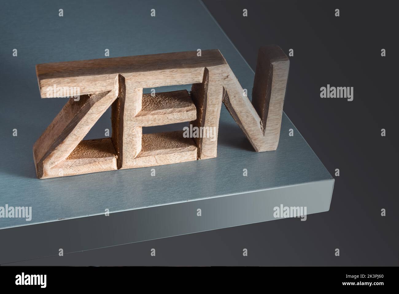 the word Zen carved in wooden letters on a grey background ,concept of ...