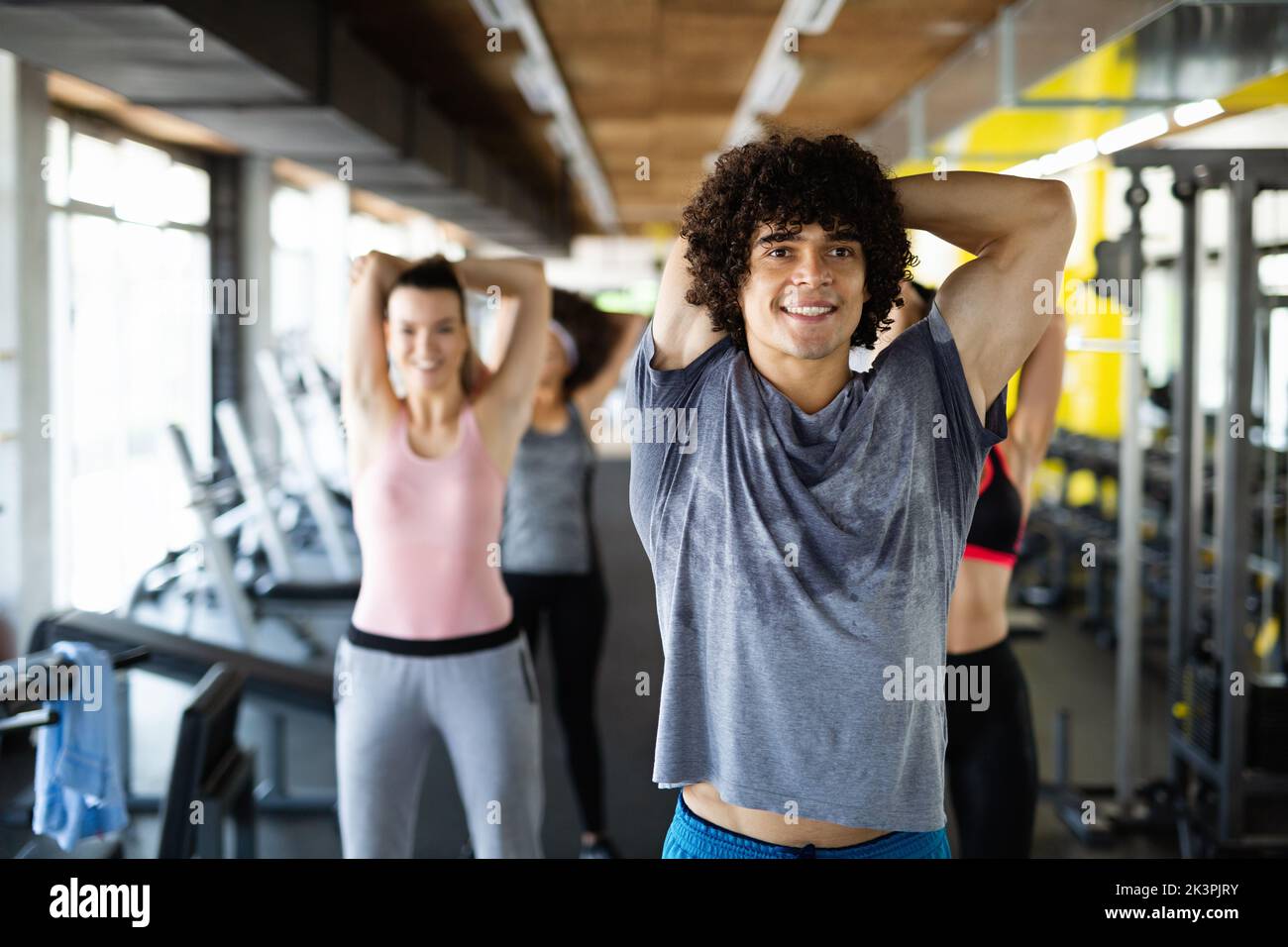 Group of fit people working out in a gym. Multiracial friends ...