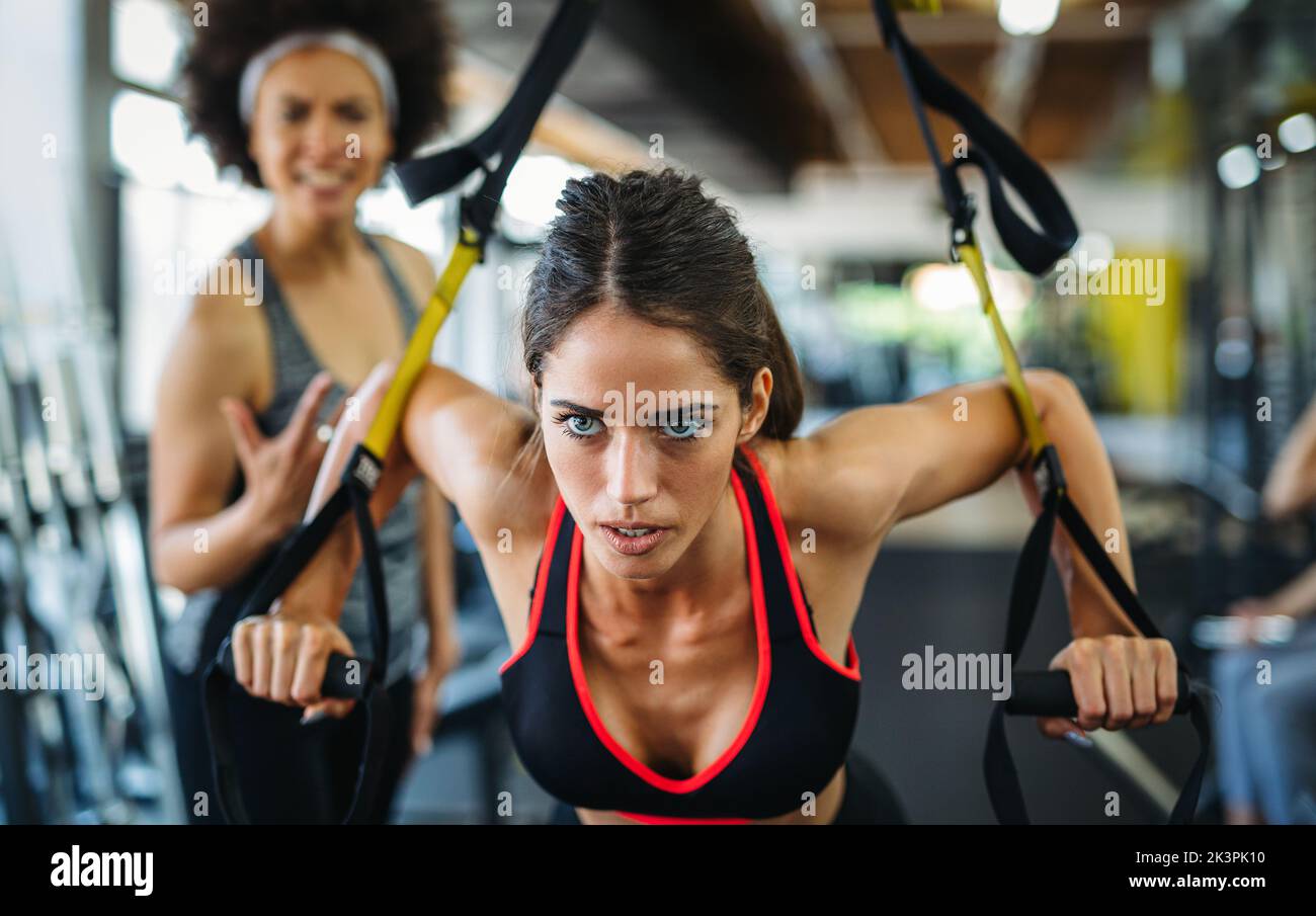 Beautiful fit women, friends working out in gym together. Sport, people ...