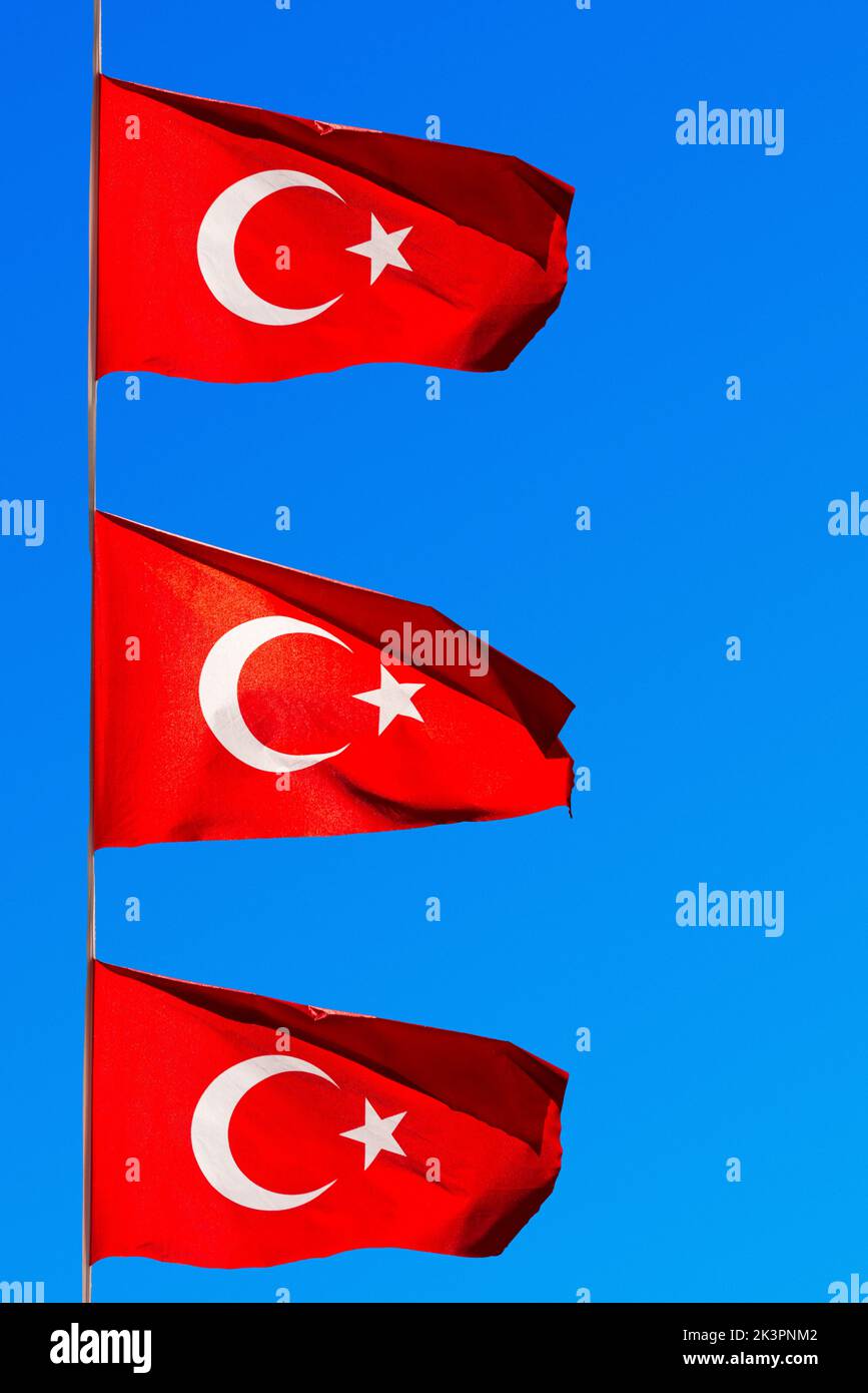 Three Turkish flags on a blue sky background Stock Photo - Alamy