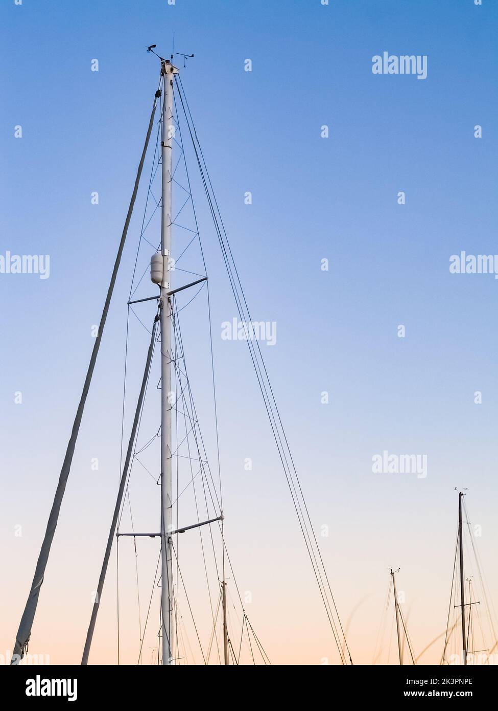 Marine theme background yachts mast against blue sky in vertical ...