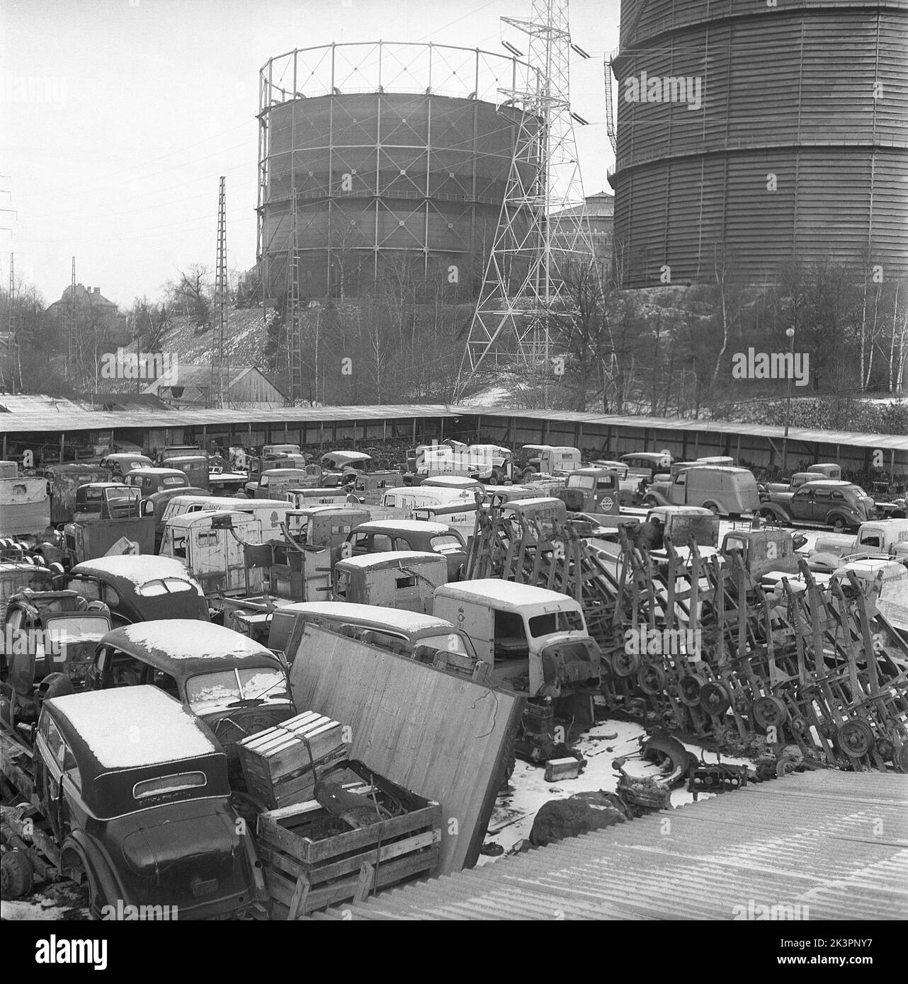 In the 1940s. A scrapyard where parts of disused cars and vehicles are ...