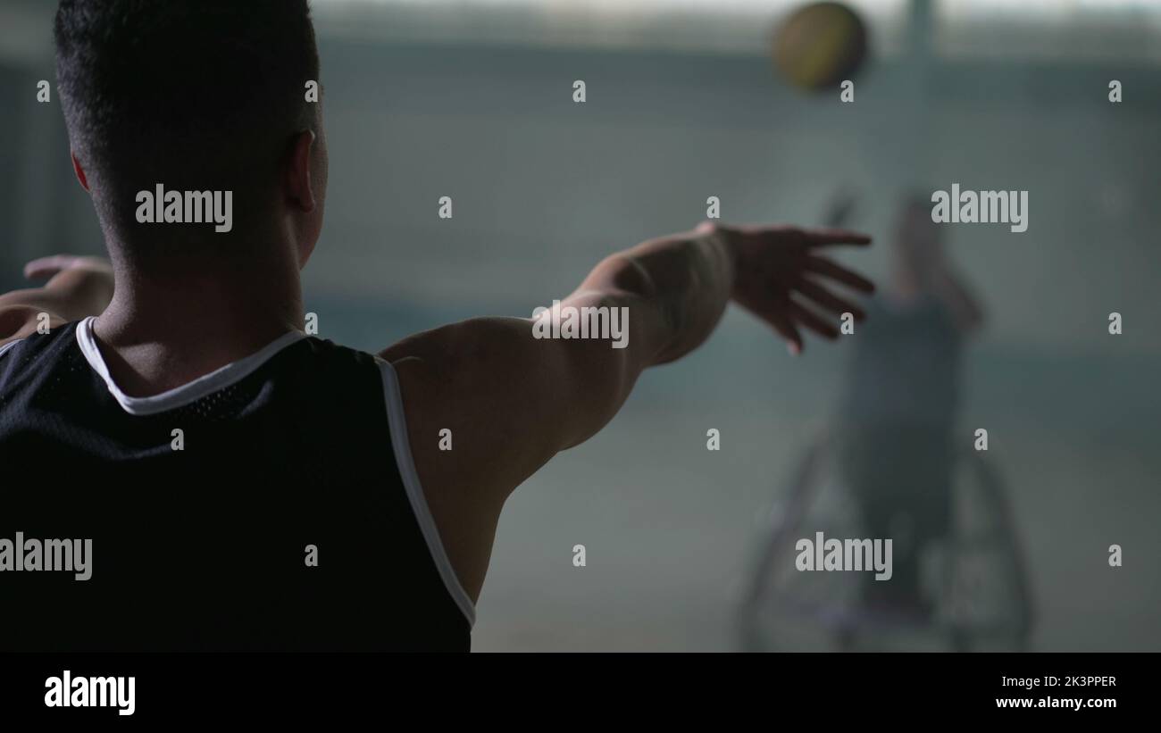 Two disabled athletes playing with basketball. Athlete with disability ...