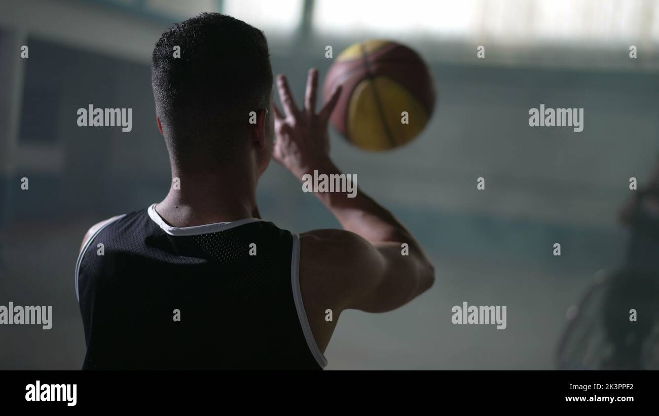 Two disabled athletes playing with basketball. Athlete with disability ...