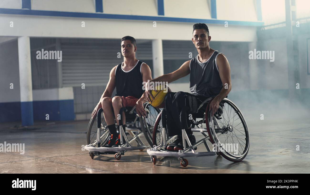 Two disabled handicapped basketball players in wheelchairs. Athletic ...
