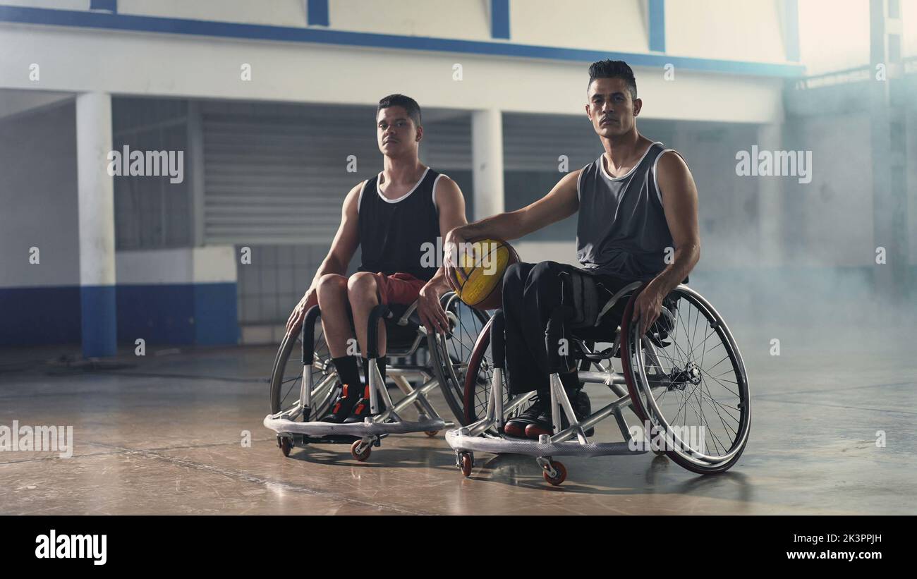 Two disabled handicapped basketball players in wheelchairs. Athletic ...