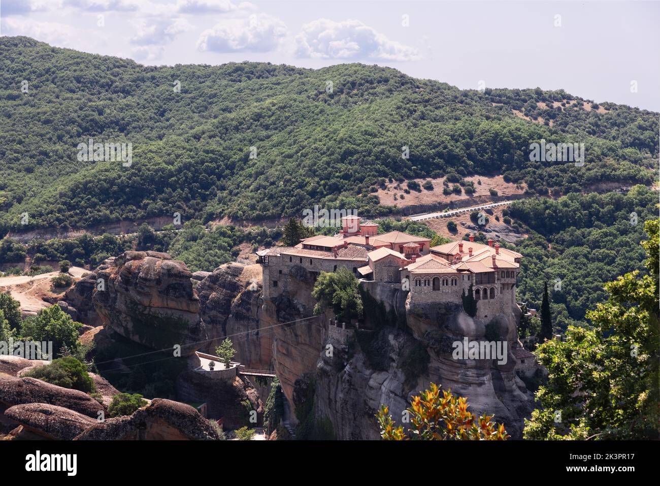 Rustic road running along forested hillside leads to the only narrow ...