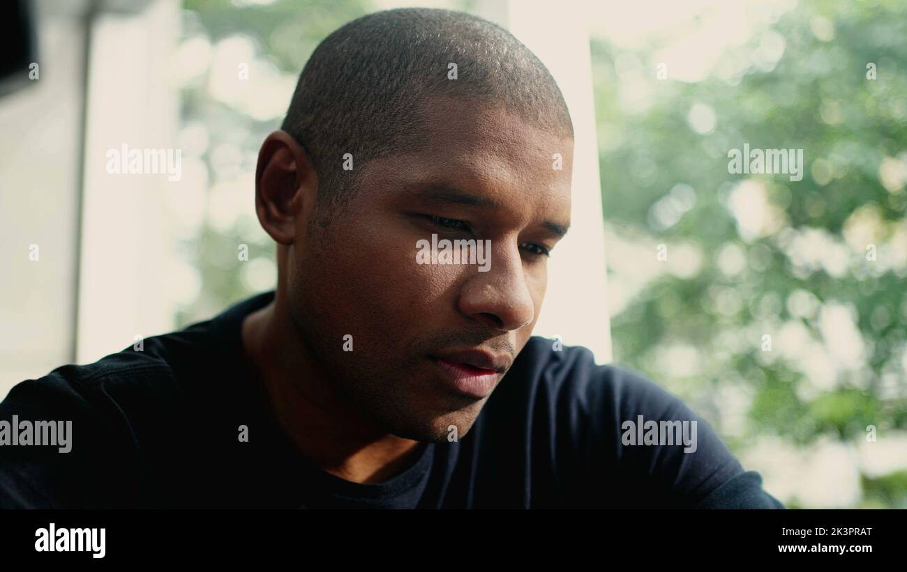 Depressed person with sad expression closeup face looking down. African ...