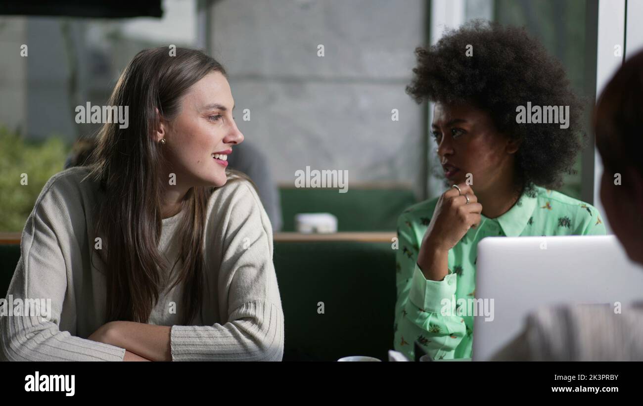 Diverse women at coffee shop in conversation. Three group of ...