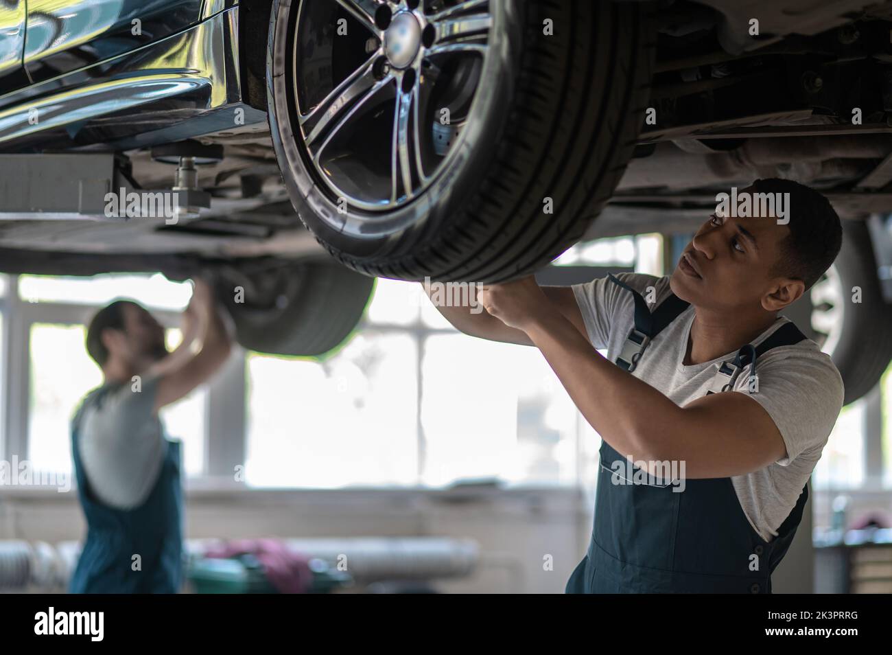 Team of auto mechanics fixing the customer vehicle Stock Photo - Alamy