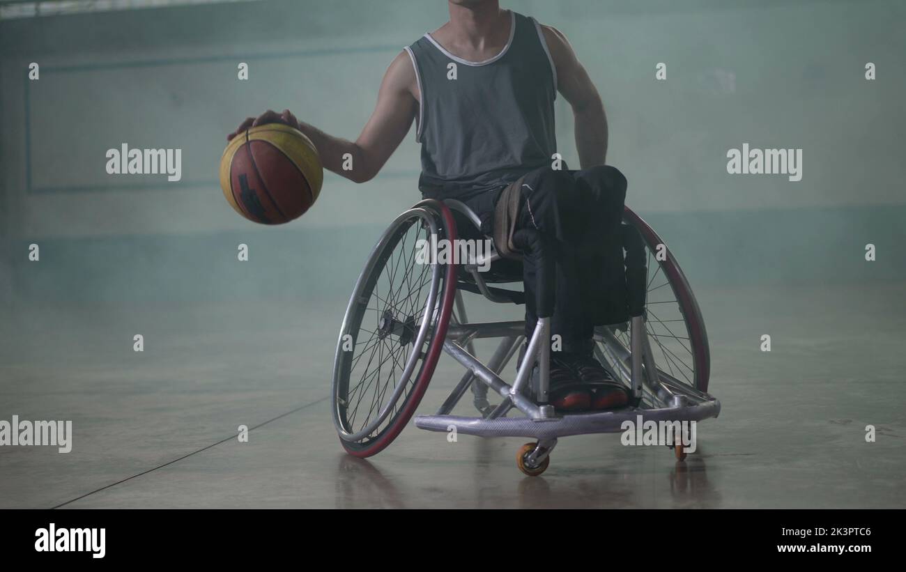 A disabled athlete in wheelchair playing basketball. Handicapped ...