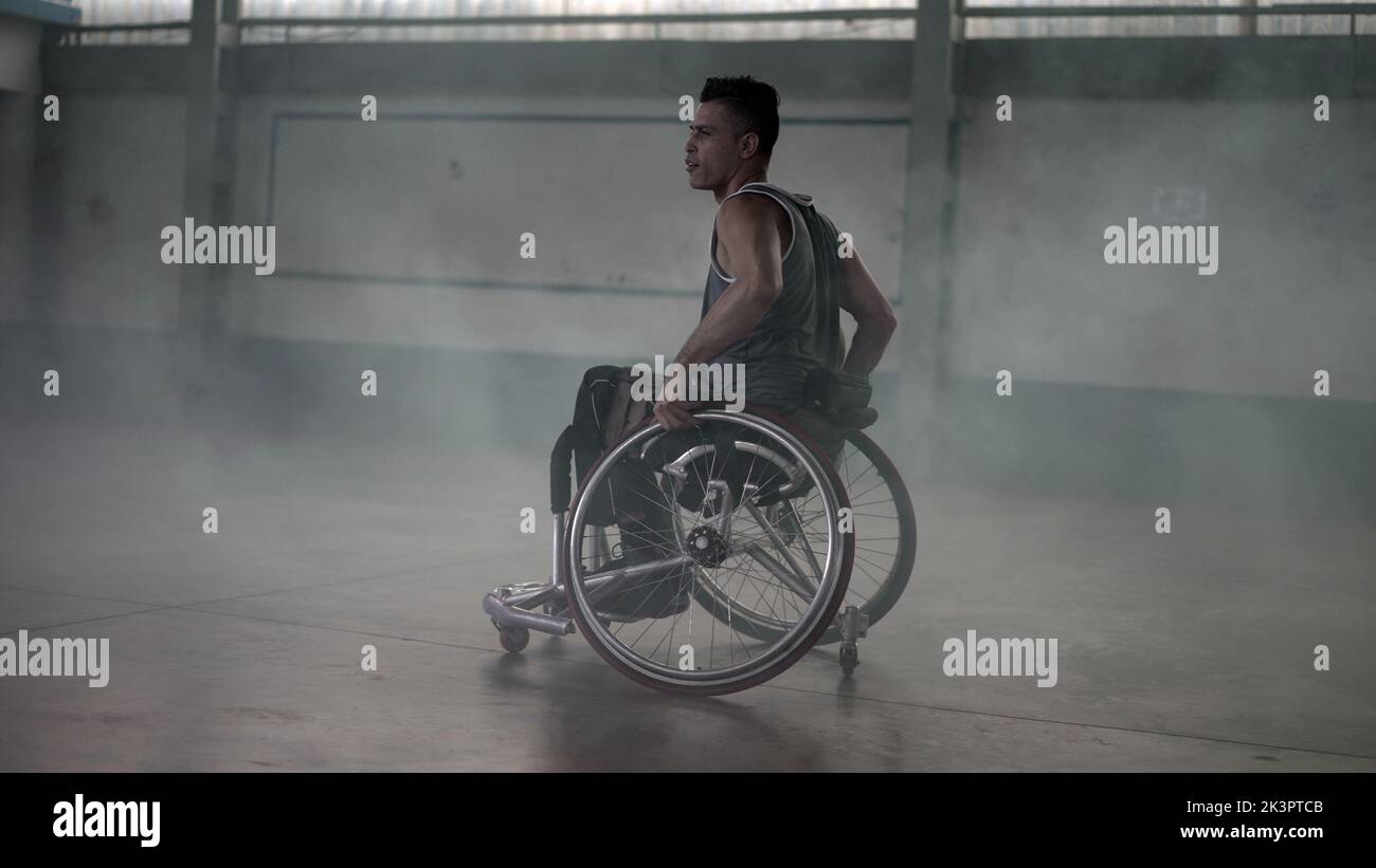 Athlete in wheelchair with disability grabbing ball and passing to team ...