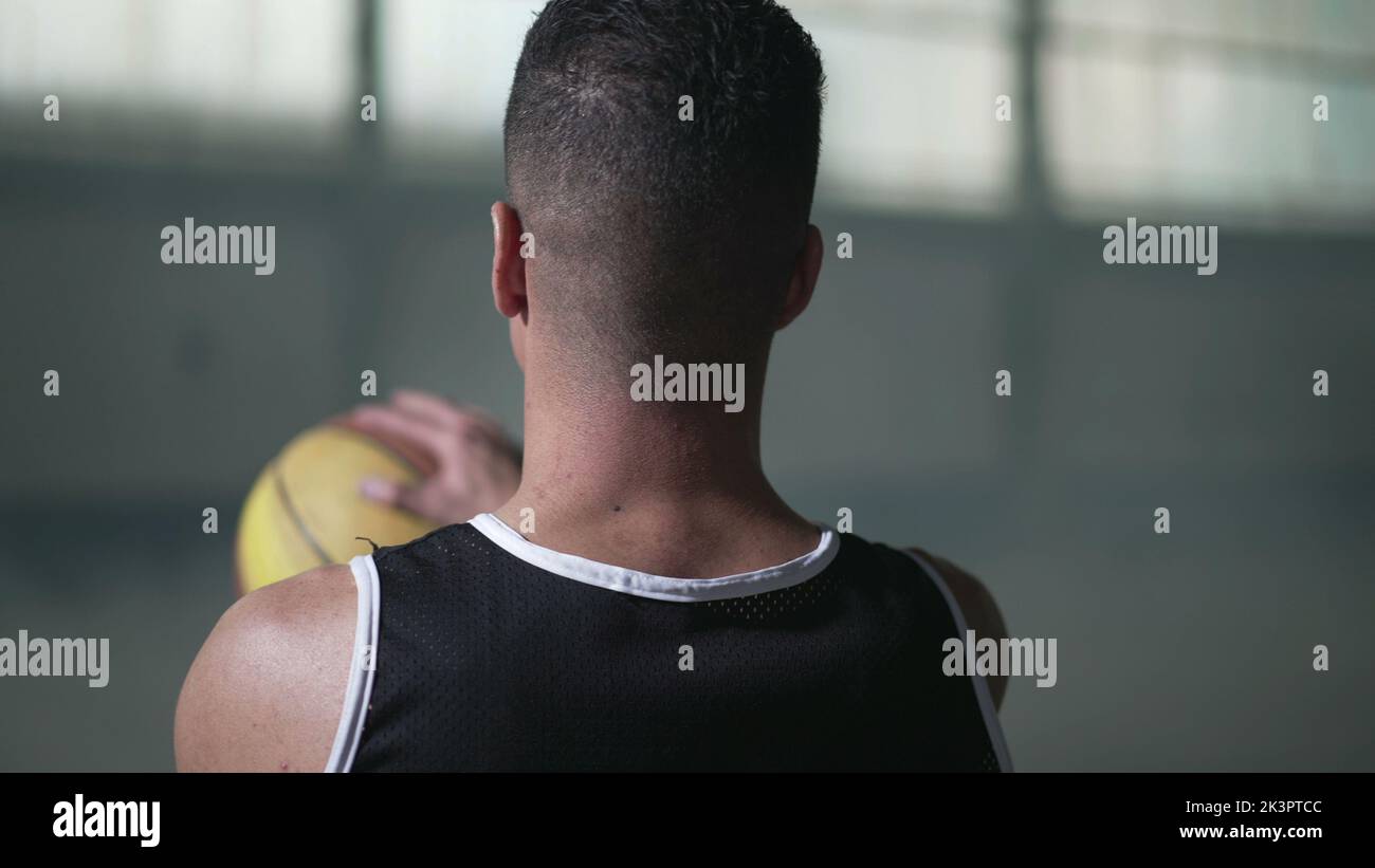 Back of basketball player catching ball. Athletic person grabbing ball ...