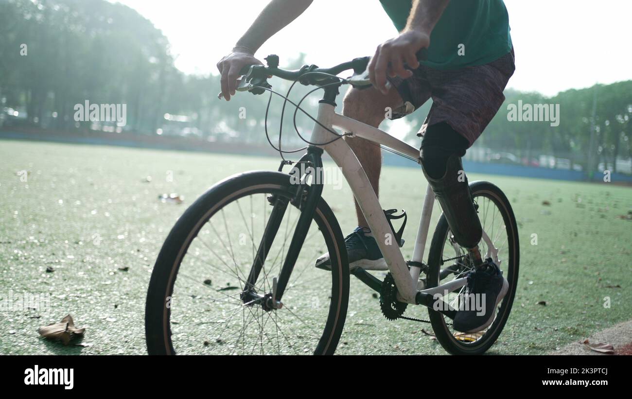 A disabled amputee cyclist riding bicycle with prosthetic leg Stock ...