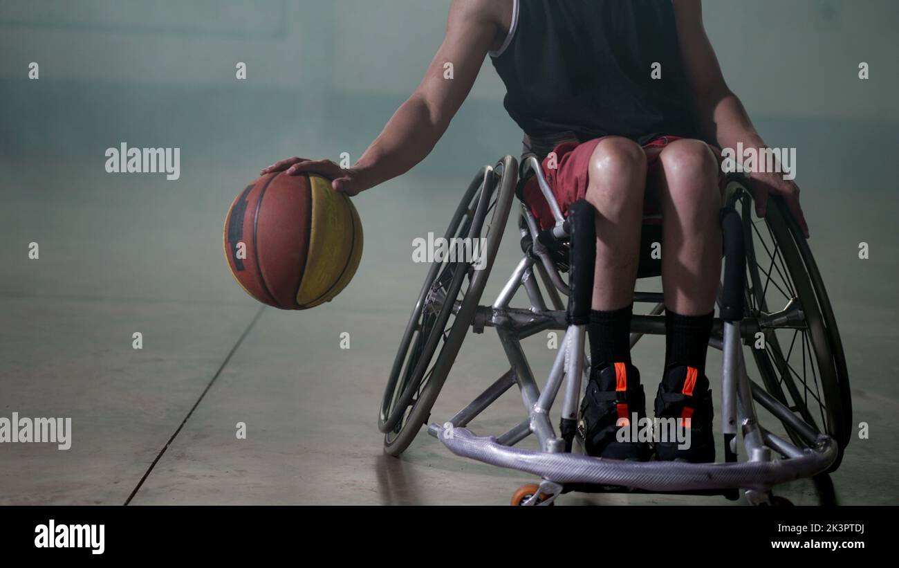 A disabled athlete in wheelchair playing basketball. Handicapped ...