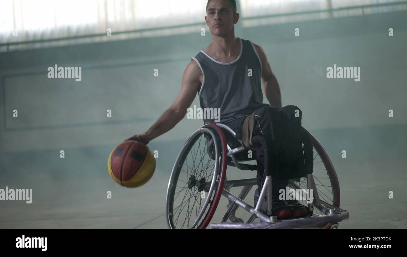 A disabled athlete in wheelchair playing basketball. Handicapped ...