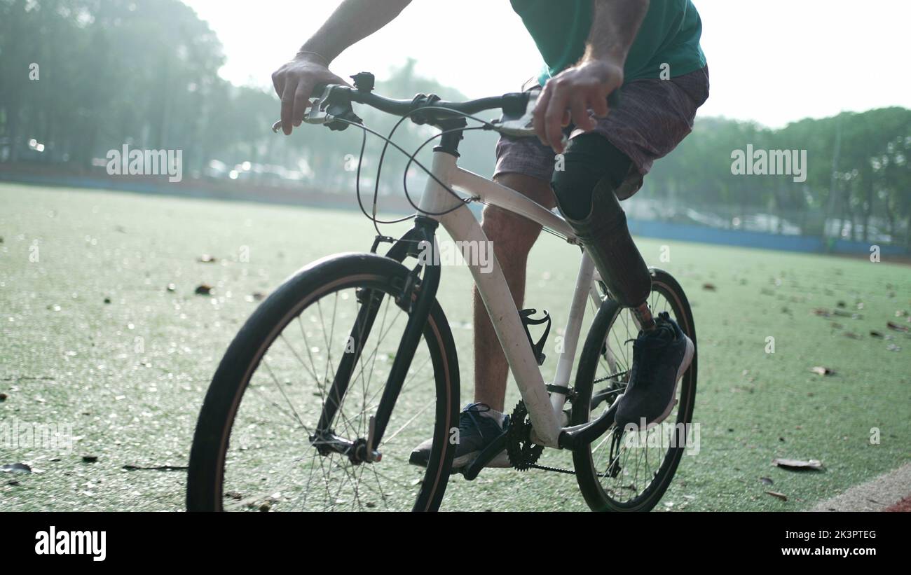 A disabled amputee cyclist riding bicycle with prosthetic leg Stock ...